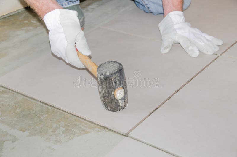 Tiler Using a Rubber Mallet Stock Image - Image of mortar, mallet: 43652655