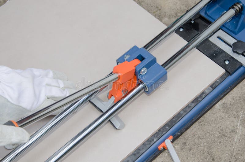 Tiler using a tile cutter stock photo. Image of tile - 43652808