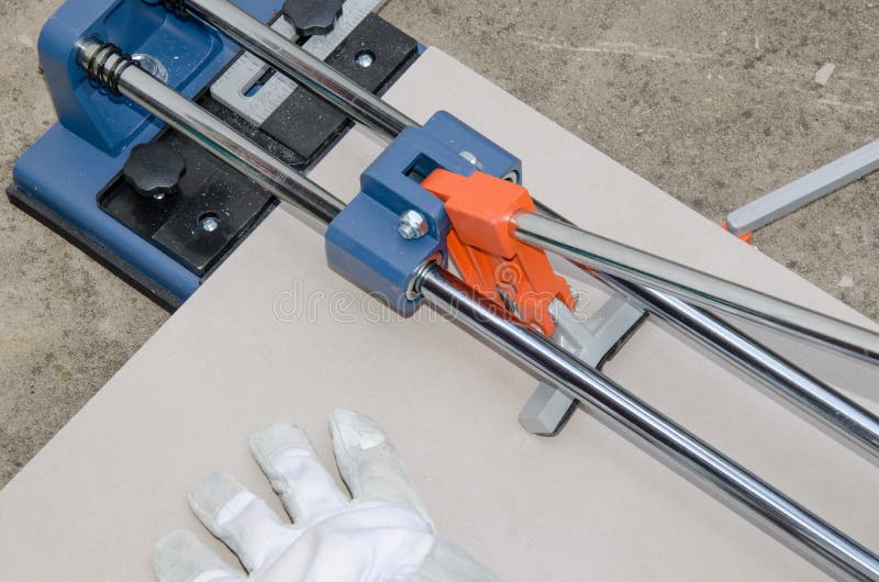 Tiler using a tile cutter stock image. Image of tile - 43652909