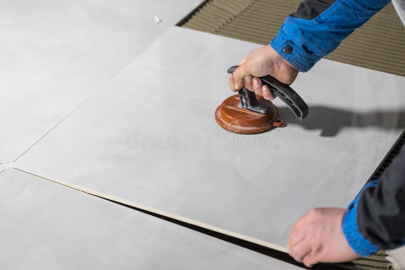 Tiler Worker Placing or Tiling Gray Ceramic Tile in the Position Over ...