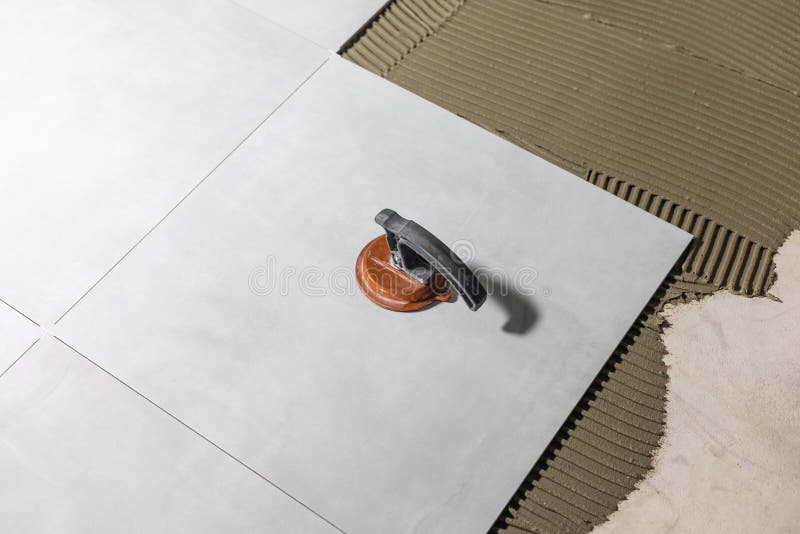 Tiler Worker Placing or Tiling Gray Ceramic Tile in the Position Over ...