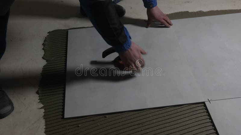 Tiler Worker Placing or Tiling Gray Ceramic Tile in the Position Over ...