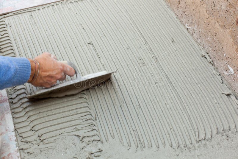 Tiler works with flooring. stock photo. Image of equipment - 44705718