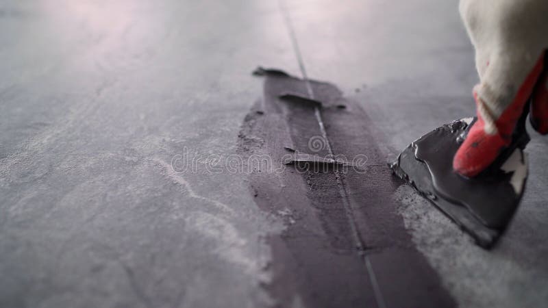 Tilers Filling the Space between Tiles Using a Rubber Trowel. Grouting ...