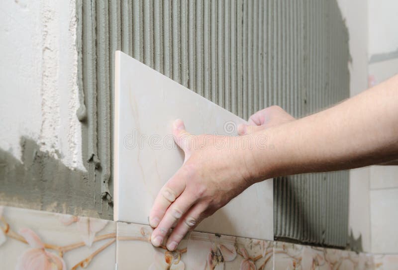 Tilers Hands are Installing a Ceramic Tile. Stock Photo - Image of ...