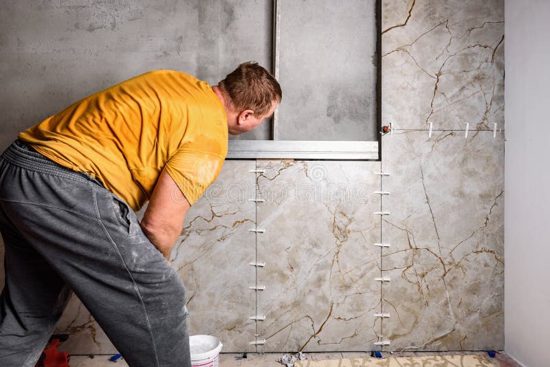 Tilers Installing Large Format Tiles on Wall. Stock Photo - Image of ...