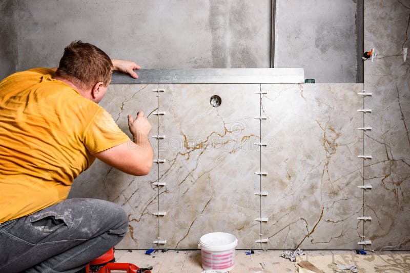 Tilers Installing Large Format Tiles on Wall. Stock Image - Image of ...