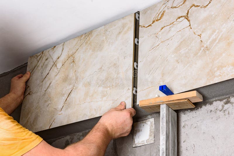 Tilers Installing Large Format Tiles on Wall. Stock Image - Image of ...