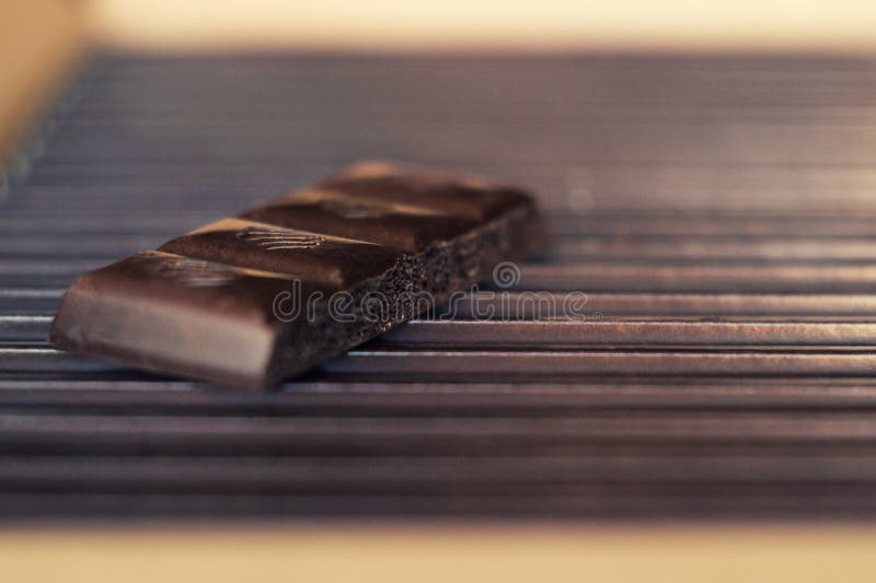 Tiles of Dark Chocolate on a Cardboard Box Packed with Chocolate. Close ...
