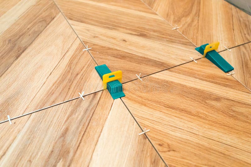 Tiling Work. the Man Checks the Level of the Correct Laying of the ...