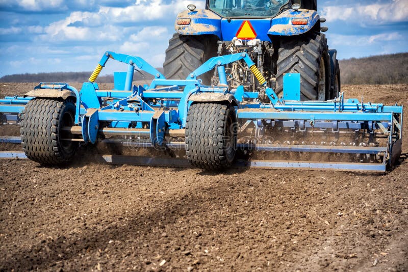 Tillage in the Field with a Tractor with a Trailed Machine Stock Photo ...