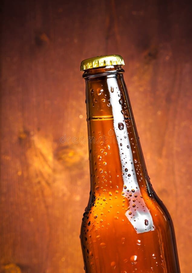 Tilted Bottle of Fresh Beer with Drops Stock Photo - Image of amber ...