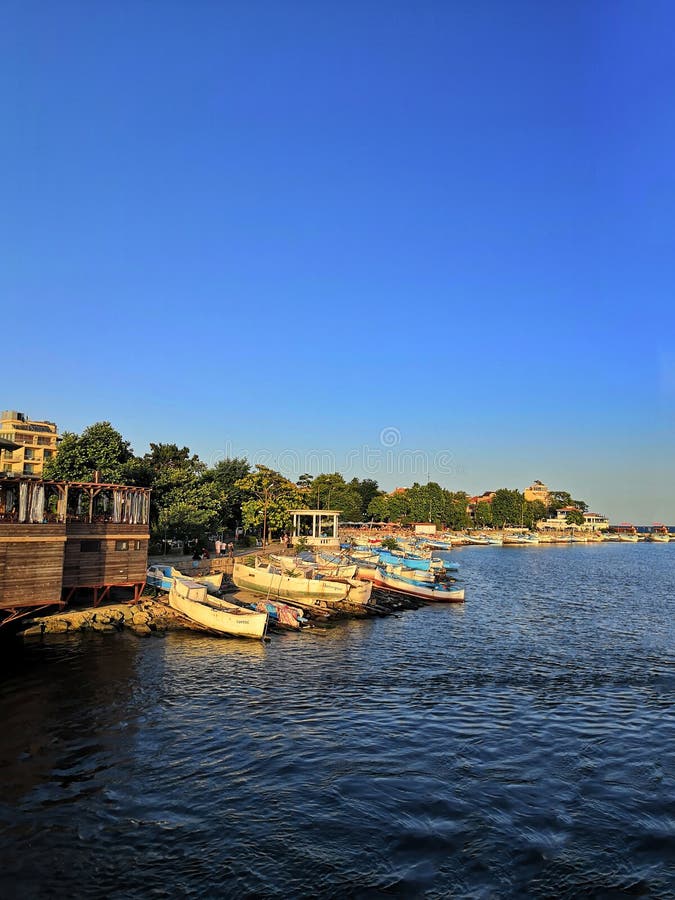 Timber Bar Stools and Table Sitting on the Sand beside a Set of Stairs ...