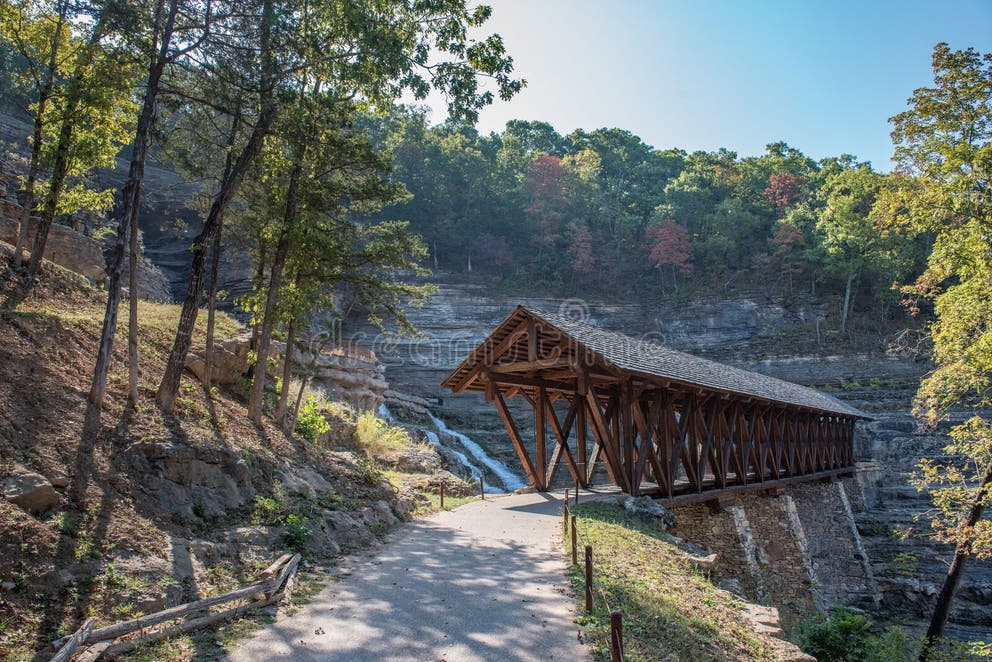 Timber Frame-covered Bridge Surrounded by Rocks, Trees and a Waterfall ...