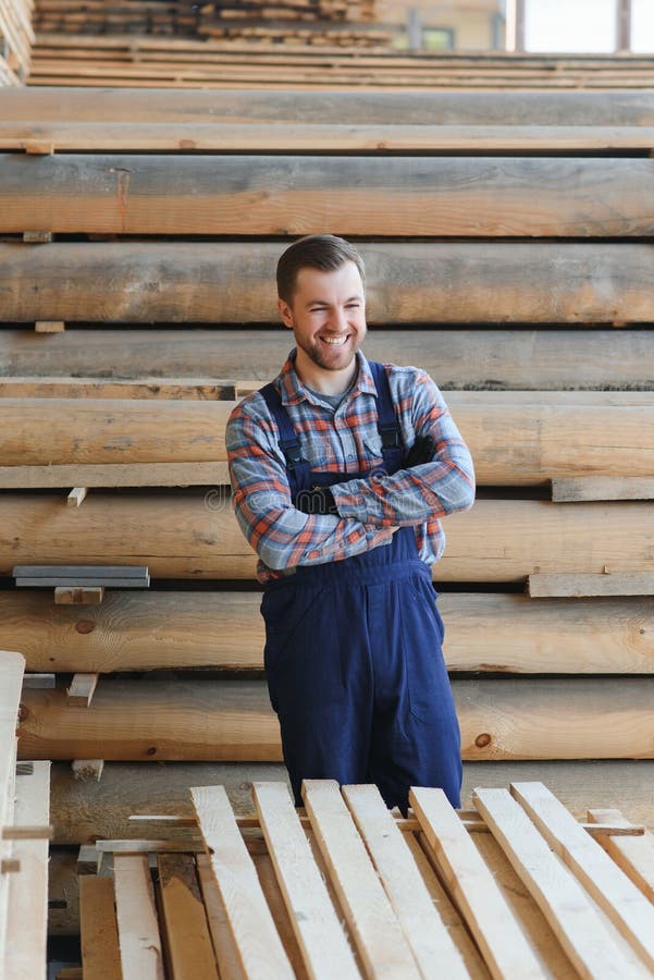 Timber Harvesting for Construction. Carpenter Stacks Boards. Industrial ...