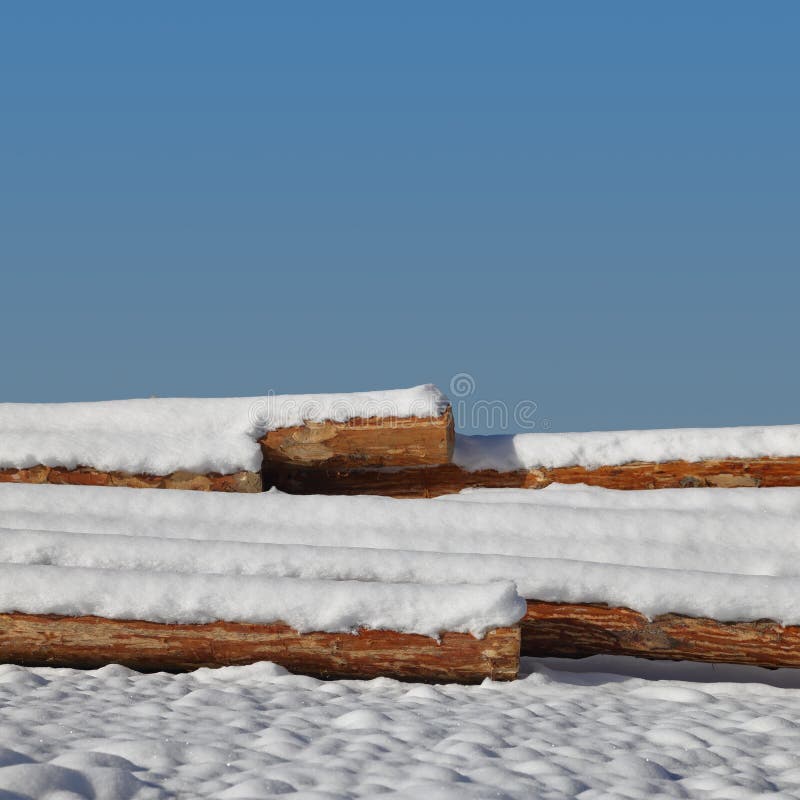 Timber stacks on snow stock image. Image of environmental - 51504997