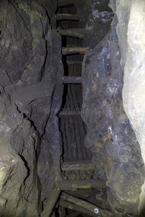 Timbers Brace a Long Open Area with Wooden Platform Inside a Mining ...