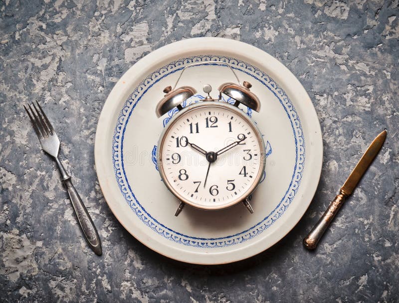 Time for Breakfast. Alarm Clock in a Plate, Fork and Knife Stock Photo ...