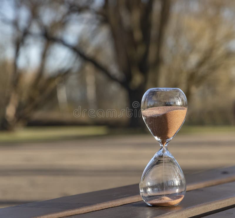 Hourglass on a bench. stock image. Image of life, glass - 182989003