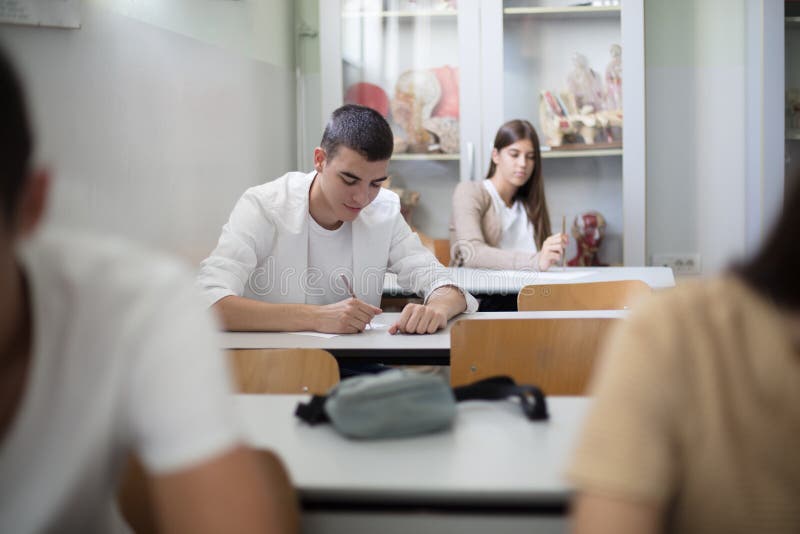 Teenagers Students Sitting in the Classroom Working Exam Stock Image ...