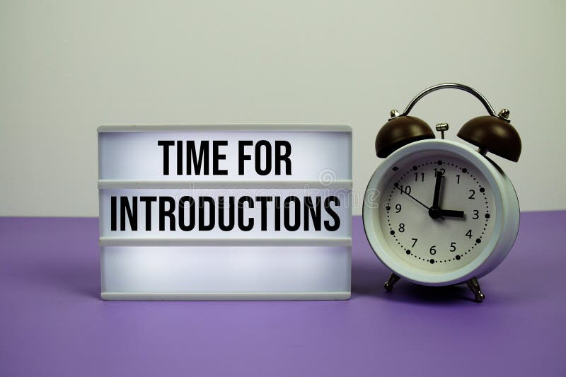 Time for Introductions Text on LED Lightbox with Alarm Clock on Purple ...
