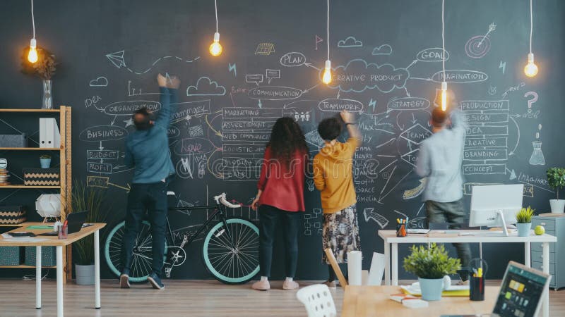 Time Lapse of Group of People Writing and Drawing on Chalkboard Wall in ...