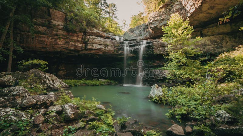 A Secluded Waterfall Crashing Down into a Crystalclear Pool Surrounded ...
