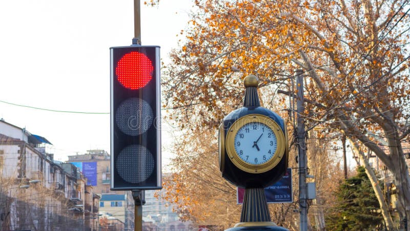 Time Lapse: Traffic Lights with a Clock on the City Background Stock ...