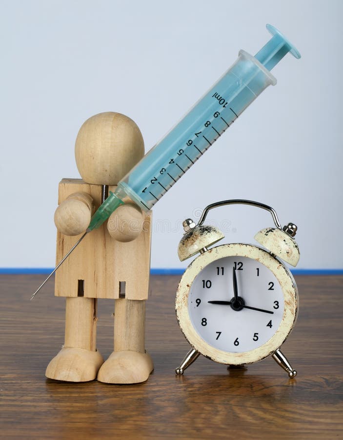 Time for Medication Concept with Wooden Man and a Syringe Stock Image ...