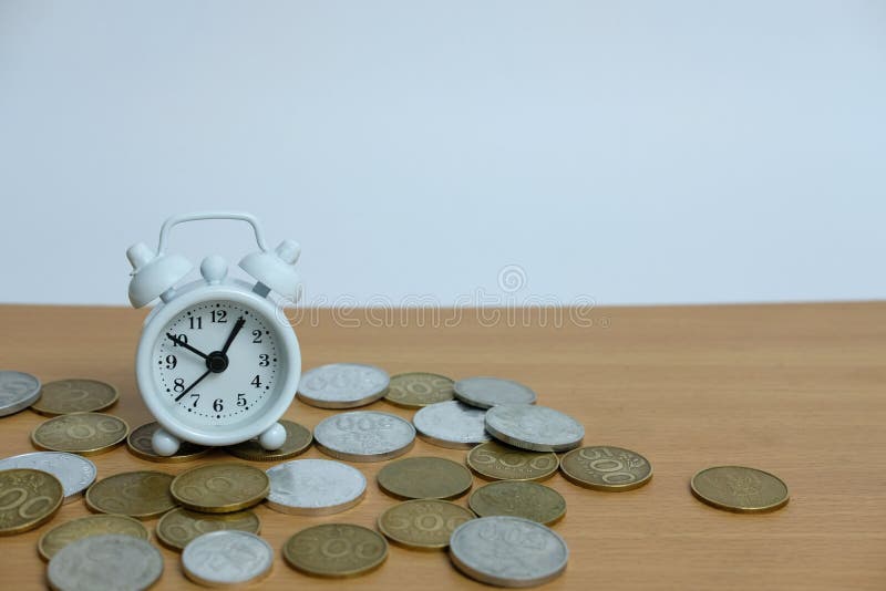 Time is Money Concept - Pile of Money with White Clock on a Wooden ...
