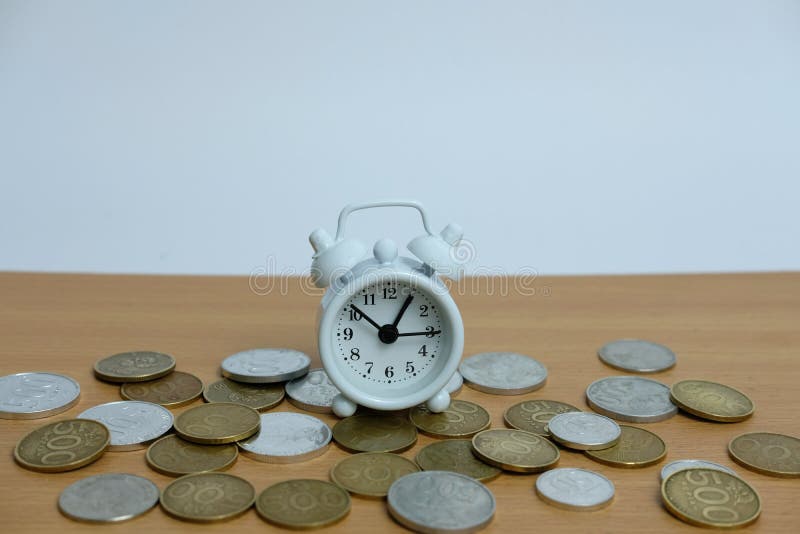 Time is Money Concept - Pile of Money with White Clock on a Wooden ...