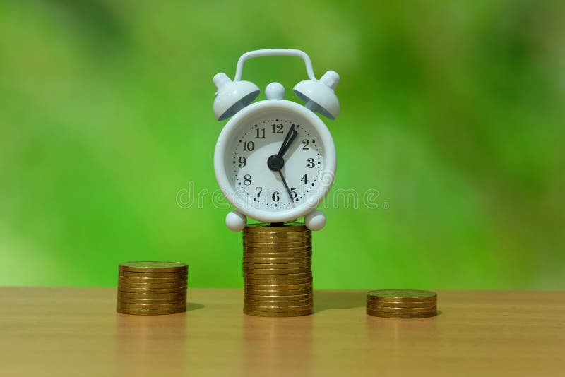 Time is Money Concept - Pile of Money with White Clock on a Wooden ...