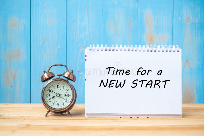 Time for a New Start Text on Notebook and Retro Alarm Clock on Table ...