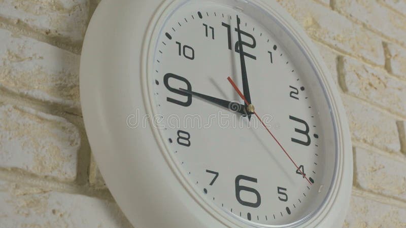 Time Nine Hours. Timelapse. Round White Clock Hanging on Brick Wall ...