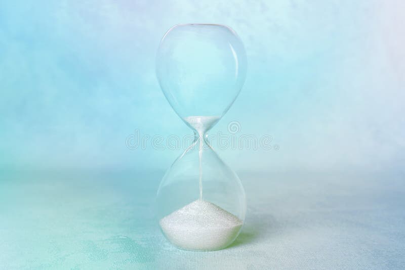 Time is Running Out Concept. an Hourglass with Sand Falling through, on ...