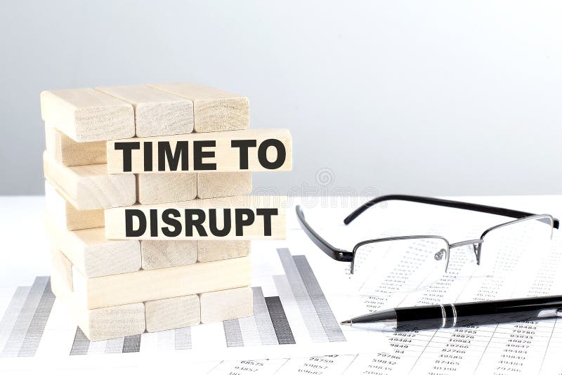 TIME TO DISRUPT is Written on Wooden Blocks on a Chart Background Stock ...