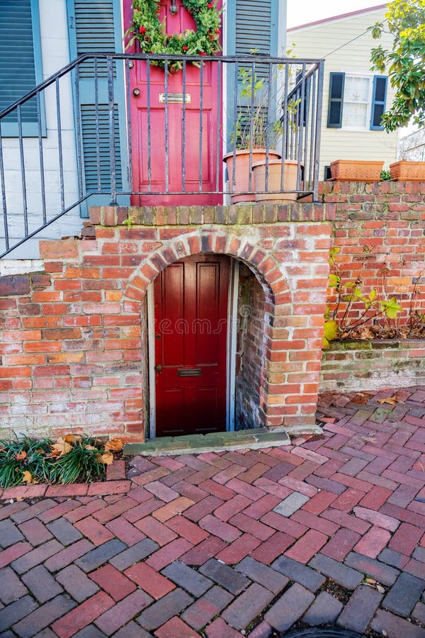 Time-worn Brickwork of the House with Wooden Red Doors. Red Brick Paved ...