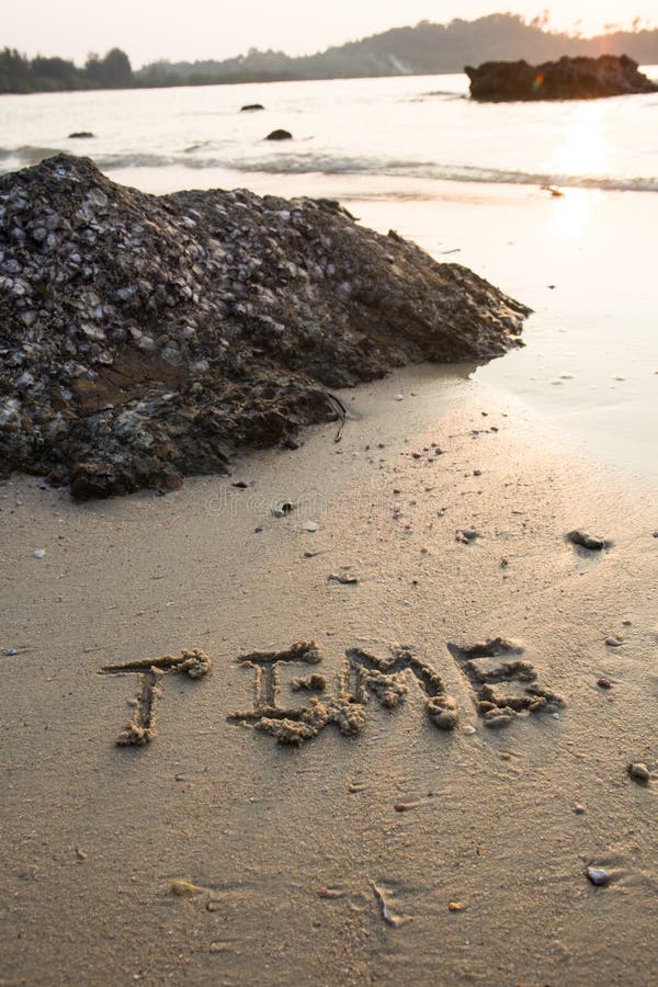Time Written in the Sand at the Beach Waves in the Background Stock ...