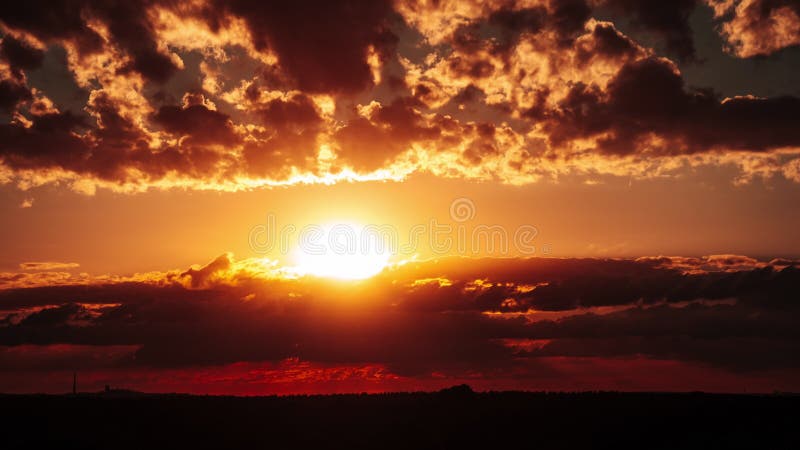 Timelapse of Epic Sunset in the Orange Sky through Layered Clouds Stock ...