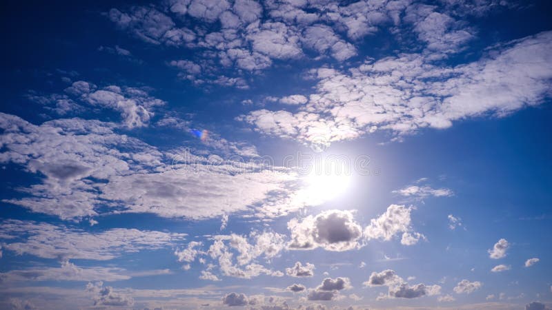 Timelapse of Fluffy Clouds Moving Under the Sun in the Blue Sky Stock ...