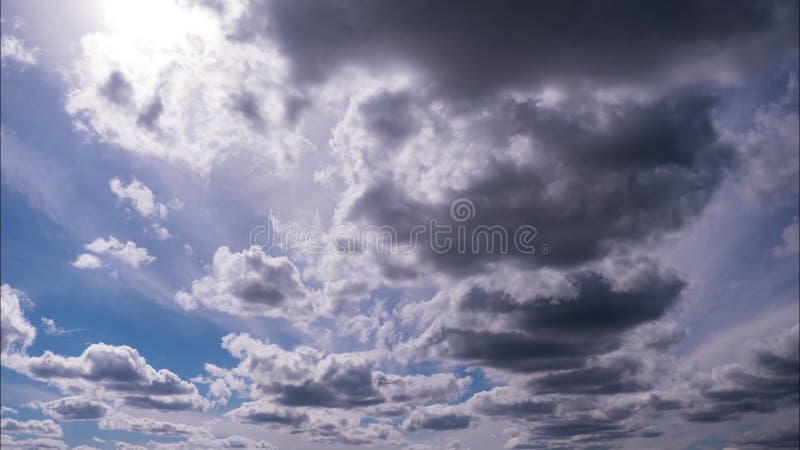 Timelapse of Fluffy Clouds Moving Under the Sun in the Blue Sky Stock ...