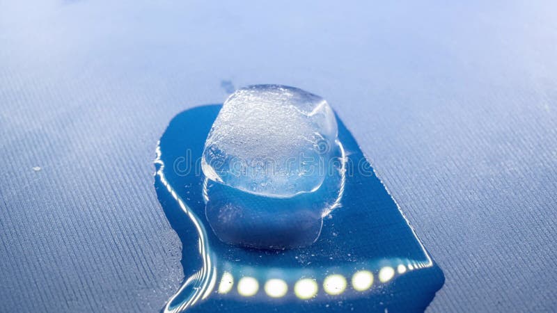 Timelapse. Melting Ice Cube on Blue Background in Backlight Stock Video ...