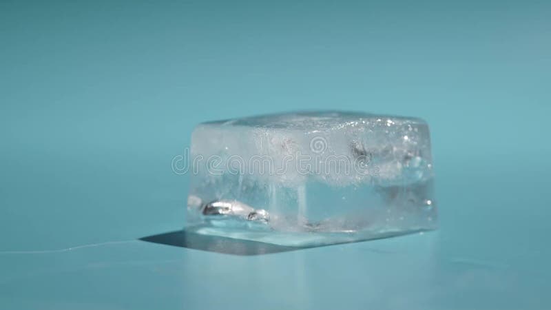 Timelapse. Melting Ice Cube on Blue Background in Backlight Stock ...