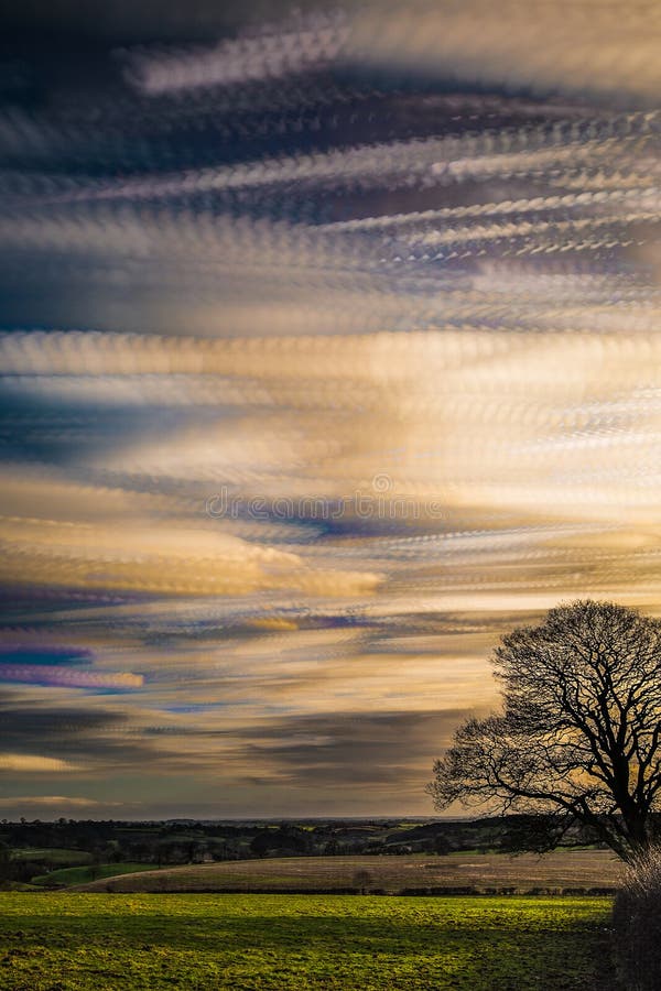Timelapse Movement of Clouds at Sunset with Silhouette of Tree and Far ...