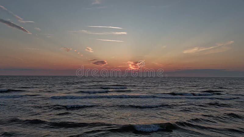 Timelapse of the Ocean at Sunset with Vibrant Sky Background Stock ...