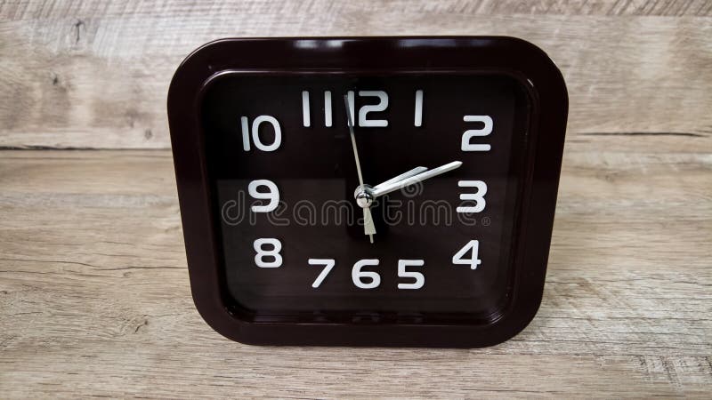 The Pointer Clock on a Wooden Table Shows the Time Stock Footage ...