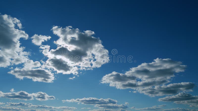 Suns Rays Pass through the White Clouds Against the Blue Sky. Open Blue ...