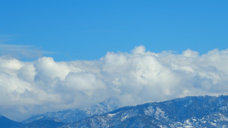 White Clouds Opposite Direction Float Across Blue Sky Past Mount ...