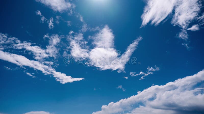 Timelapse of Wispy Clouds Forming Against Deep Blue Sky Sun Flare Stock ...