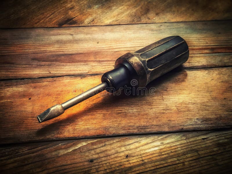 A Timeless Tool a Worn Black Screwdriver Rests on Rustic Wood Capturing ...